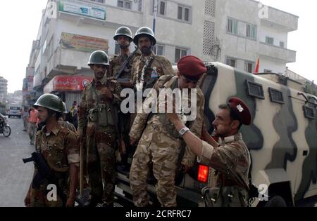 Saudi Arabian soldiers stand guard near the border with Kuwait ...