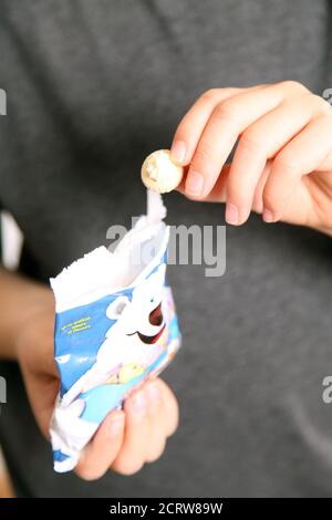 A child takes a McVitie's Iced Gem biscuit from packet Stock Photo - Alamy