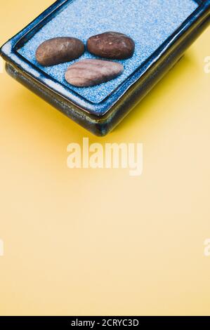 Vertical shot of a rectangular box filled with small blue rocks on ...