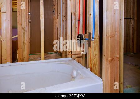 Interior framing of bathroom a new acrylic bathtub with a wood frame ...