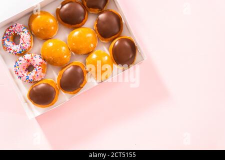 Flat lay. Variety of store-bought doughnuts in a white paper box Stock ...