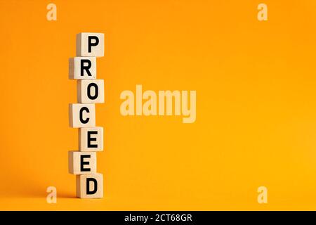 Proceed, word in wooden alphabet letters isolated on colourful ...