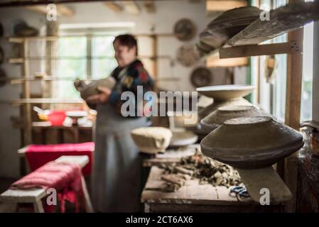 Woman decorating Horezu ceramics, a unique type of Romanian pottery ...