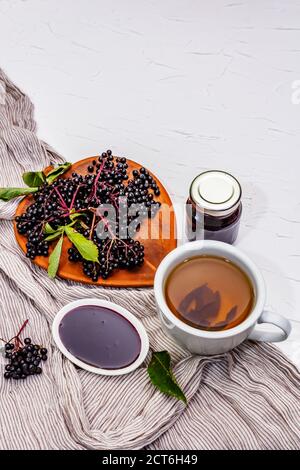 Elderberry jam, syrup, confiture and hot tea. Ripe berries, sweet and ...
