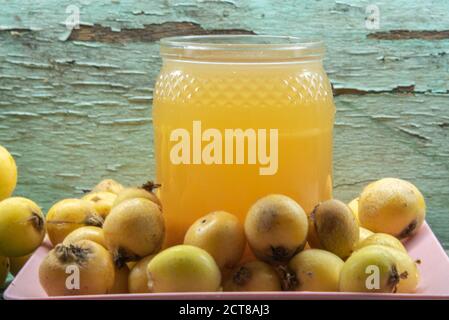 Yellow medlar fruit juice (Eriobotrya japonica). Plant of the botanical ...