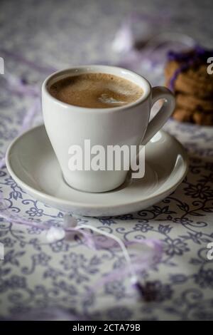 Cup of hot coffee, chocolate cookies and autumn leaves on a wooden ...
