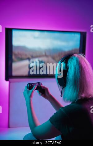 Back Shot of a Gamer Girl Playing First-Person Shooter Online Video ...