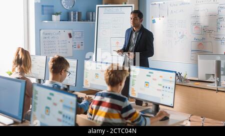 Elementary School Classroom: Smart Boy Uses Personal Computer, Learning ...