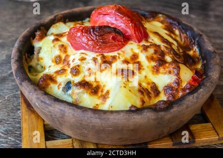 Georgian traditional dish with potatoes and cheese, Tashmijabi. Human ...