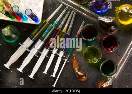 Multicolored and colorful medical needle and lab glassware with ...