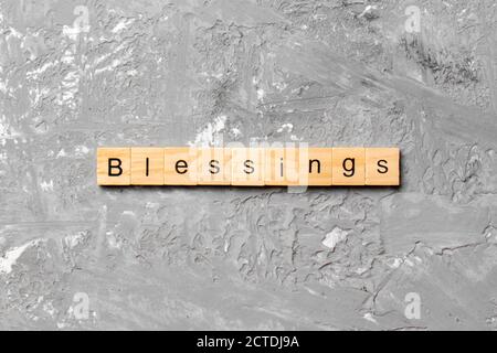 Blessings word written on wood block. Blessings text on cement table ...