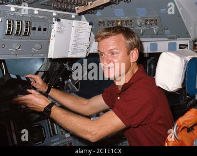 STS-36 Pilot John H. Casper reaches for the shuttle portable onboard ...