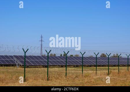 a solar power plant protected by barbed wire Stock Photo - Alamy