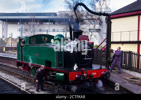 A steam engine refilling water in station Stock Photo - Alamy