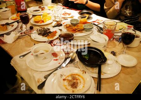 --FILE--Waiters clean plates at a buffet restaurant where food waste is ...