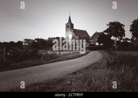 Medieval church in the floodplains on a dike of a Dutch river landscape ...