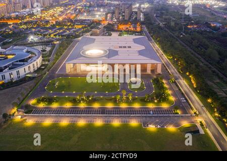 An aerial view of edifices with lights on standing in the Dream Town ...
