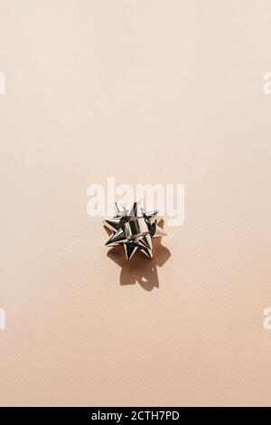 Pink Gift box with silver bow in mint background with shiny confetti ...