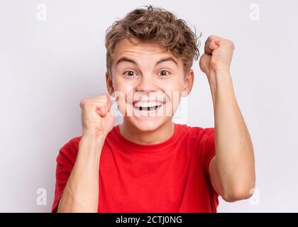 Boy excited expressing winning gesture, celebrating victory triumphant ...