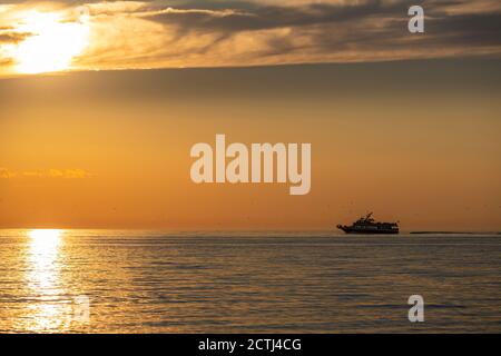 Tourists boat around Race Point Beach at sunset, Provincetown ...