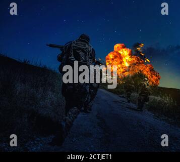 soldiers squad in action on night mission using laser sight beam lights ...