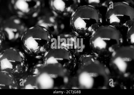 Metal balls with shiny reflections. The balls are arranged next to each ...