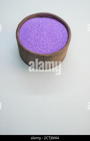 Shot of colored violet sand in bowls with some natural stones Stock ...