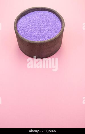 Shot of colored violet sand in bowls with some natural stones Stock ...