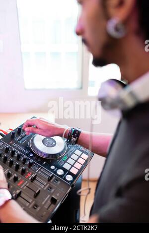 Young hispanic man mixing color at art studio Stock Photo - Alamy