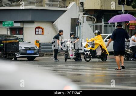 Motor, pedestrians and vehicles trek in the downpour, which might be ...