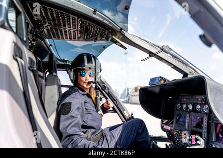 Female Pilot In Cockpit Of Helicopter Before Take Off Stock Photo - Alamy