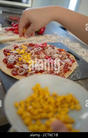 cropped image of girl in red dress and black jacket holding poker cards ...