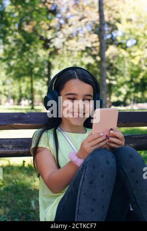 Smiling girl using smart phone lying on carpet at home Stock Photo - Alamy
