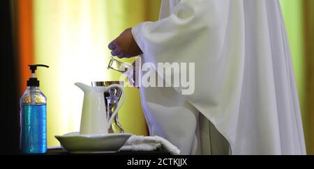 Priest washing hands, Catholic Mass, La Roche-sur-Foron, Haute-Savoie ...