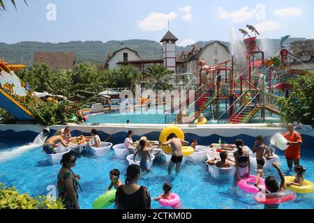 Tourists eat hotpot while sitting in a ice bucket to enjoy spicy ...