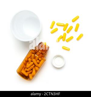 Pills spilled out of a drug bottle. Vitamins pouring out of a ...