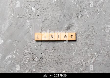 listen word written on wood block. listen text on table, concept Stock ...