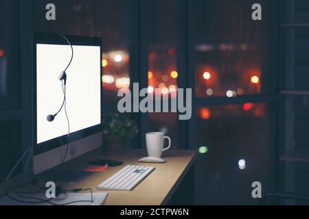 Desktop computer with illuminated screen at workstation in medical ...