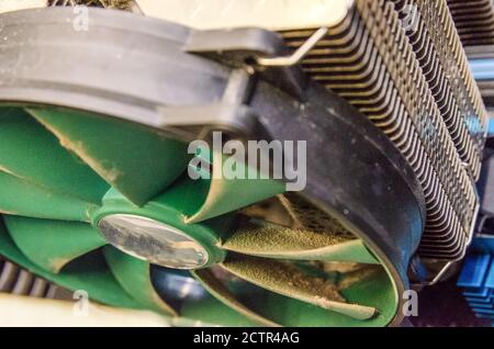 Dust on green CPU cooler PC computer with motherboard and computer case fragment close up Stock ...