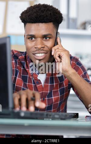Young handsome repairman repairing computer Stock Photo - Alamy