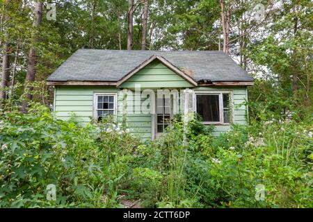 old abandoned one-story building dark without windows and doors, destroyed building in Ukraine ...