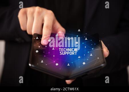Businessman holding a foldable smartphone, technology concept Stock ...