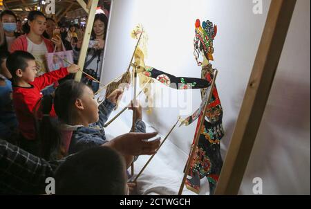 Children experience shadow puppetry in the cultural museum of Fengrun ...