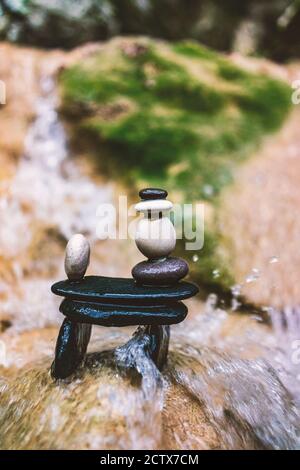 Balanced Zen stones pebbles at the waterfalls Stock Photo - Alamy