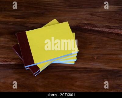 Yellow color bill books or receipt books on a wooden surface, close up ...
