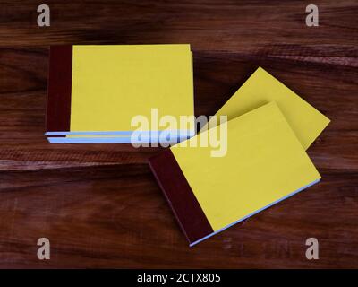 Yellow color bill books or receipt books on a wooden surface, close up ...