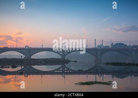 India, Uttar Pradesh, Lucknow, Bridge over Gomti River with Clock Tower ...