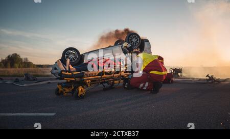 Team of Paramedics Perform Emergency First Aid to Injured Mother and ...