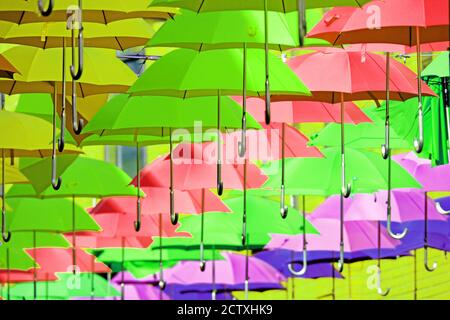 Multi coloured street decorated brollies Stock Photo - Alamy
