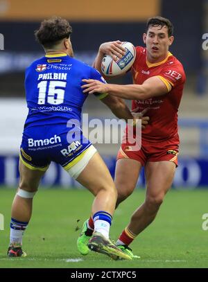 Joe Philbin of Warrington Wolves is tackled by Tyler Dupree of Wigan ...